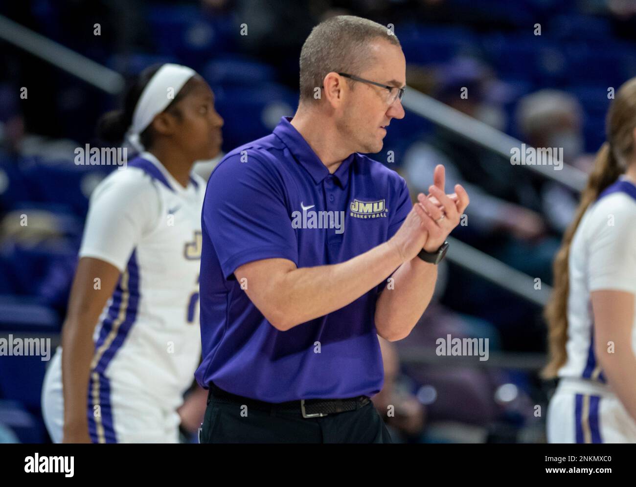 James Madison coach Sean O'Regan applauds the team after a timeout was ...