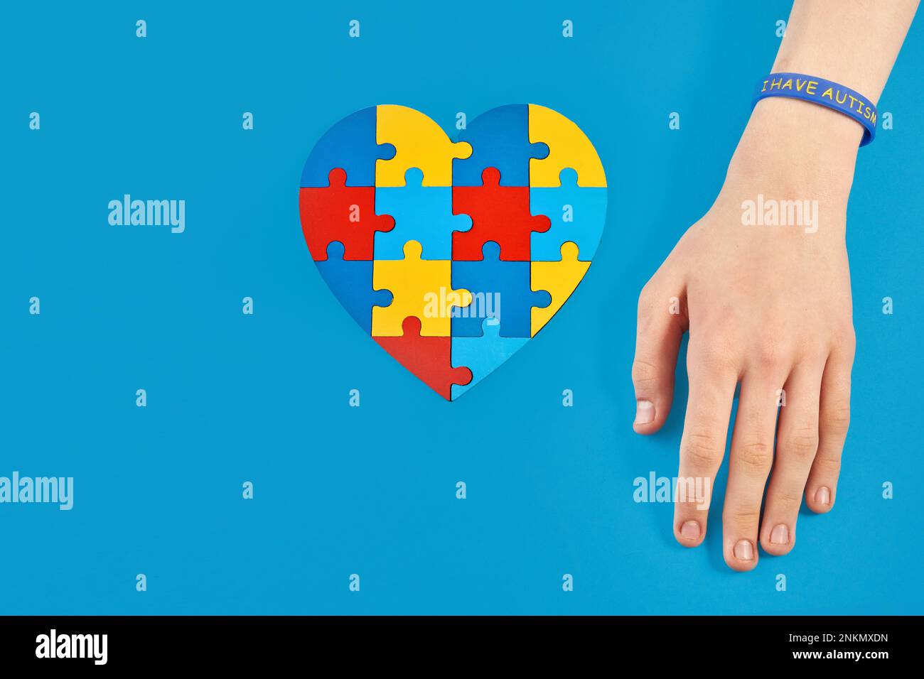 Autistic boy hand and jigsaw puzzle heart shape. World Autism Awareness ...