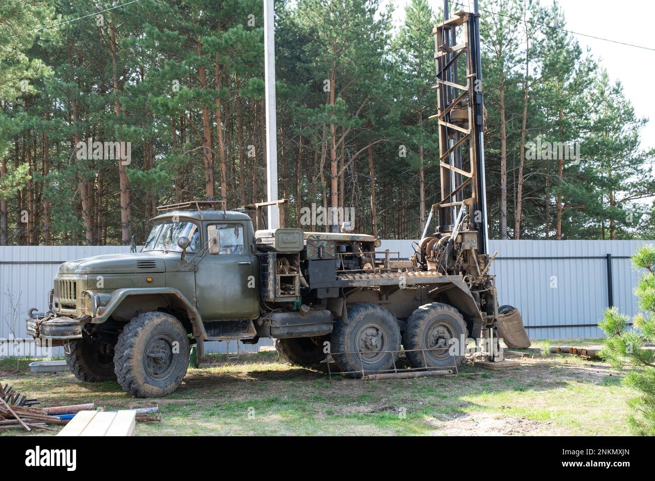 Drilling rig on zil car are drilling artesian well for water in ground ...