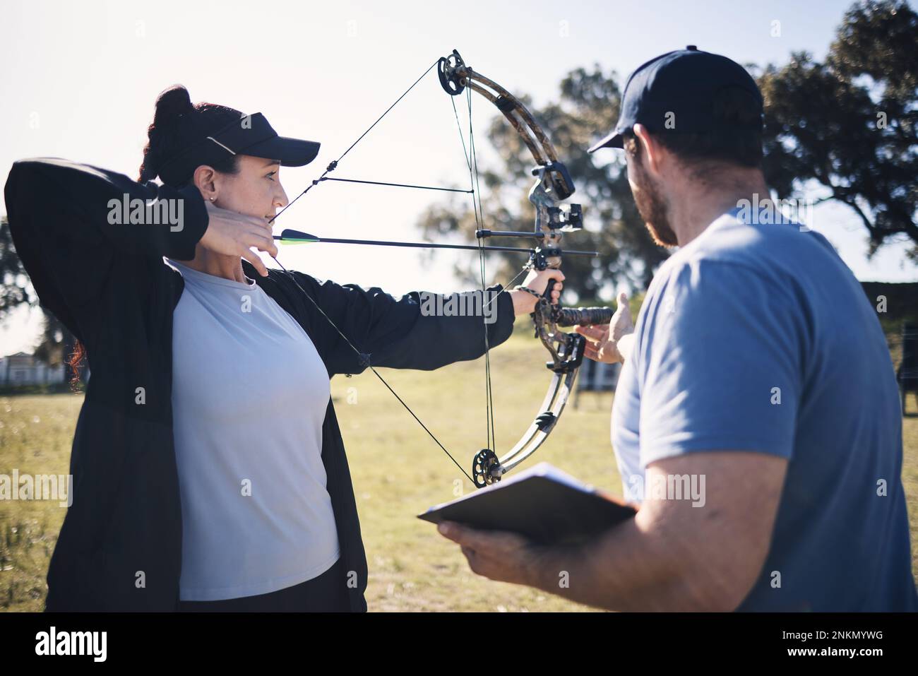 Archery, bow and arrow with woman and coach, aim at target with sports ...