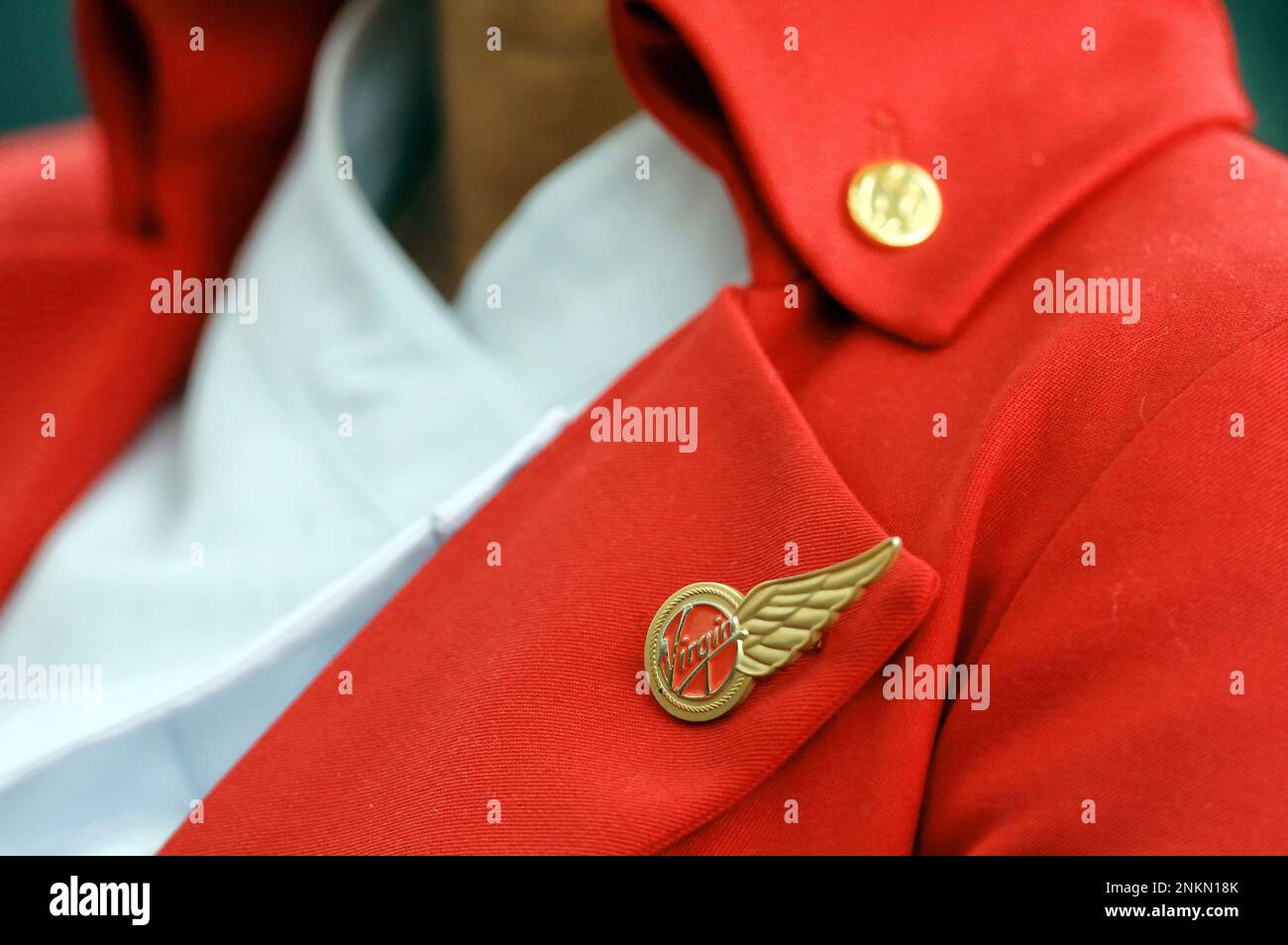 A flight attendant wears red during a press conference announcing ...