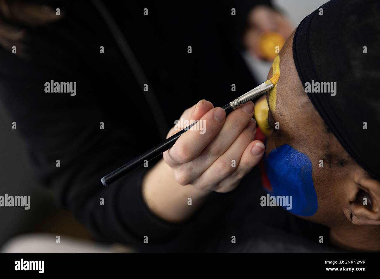 A makeup artist applies makeup to actress Lindiwe Mkhize, who plays ...