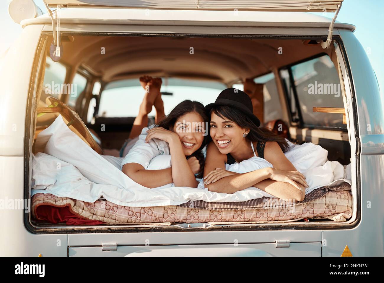 Bestie bucket list. two happy friends relaxing on a blanket in the true ...