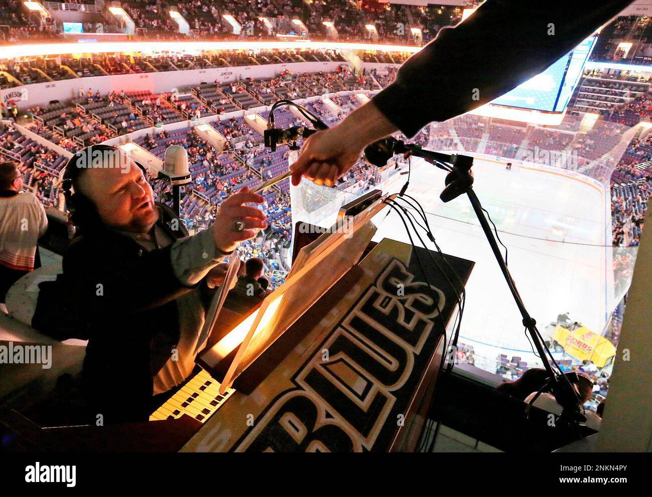 FILE - Jeremy Boyer, the organist for the St. Louis Blues NHL hockey team, is handed a candy ...