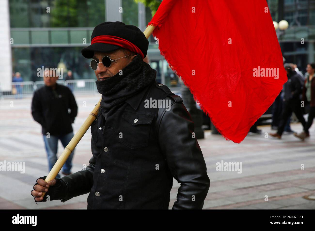 A man holds a Communist flag during as anti-fascist demonstrators clash ...