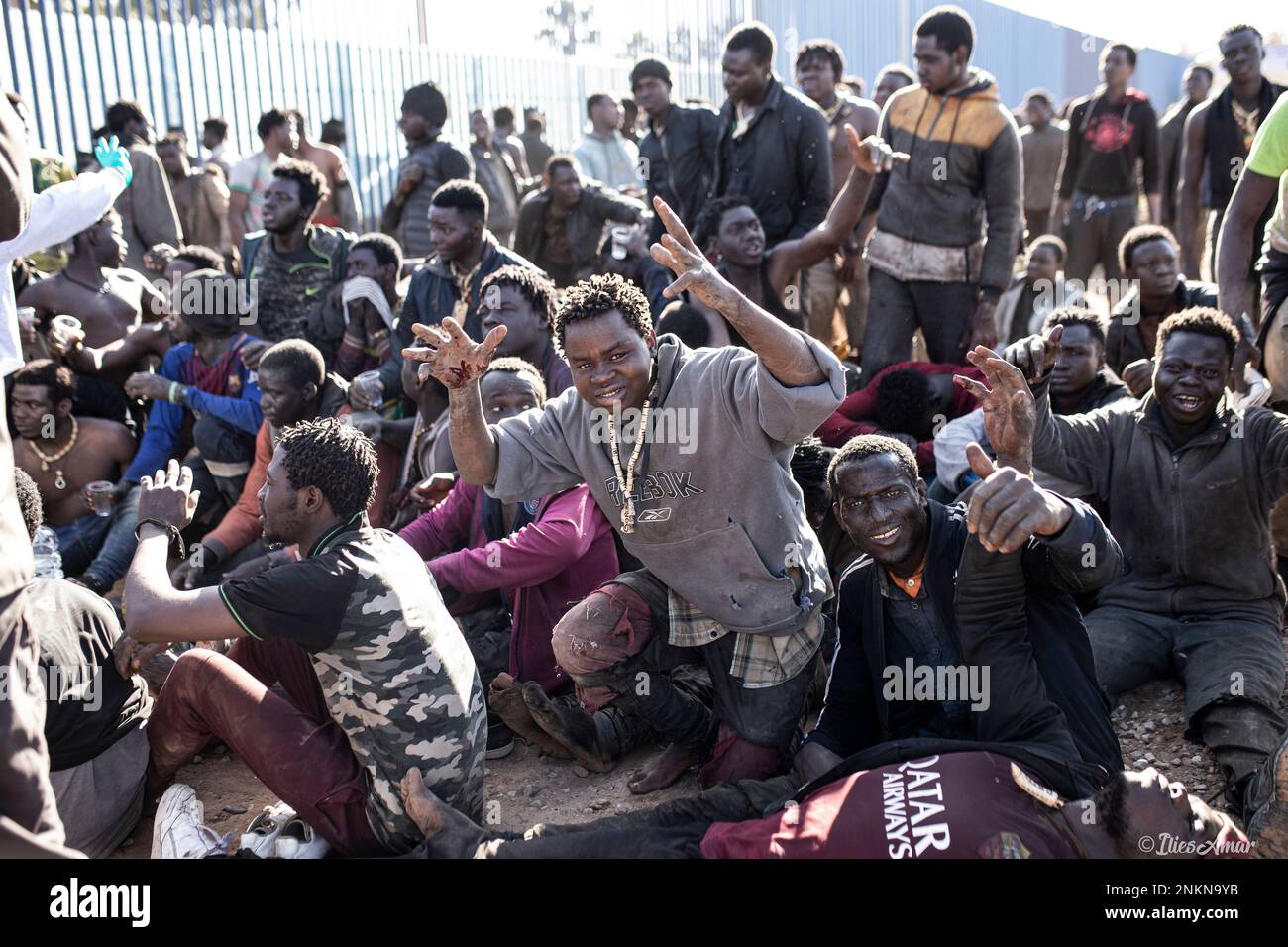 A migrant walks along the road, after jumping the Melilla border fence ...