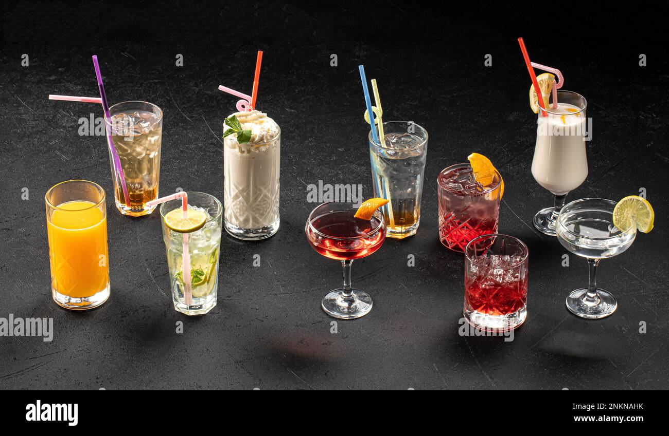 Variety of different cocktails on grey background Stock Photo - Alamy