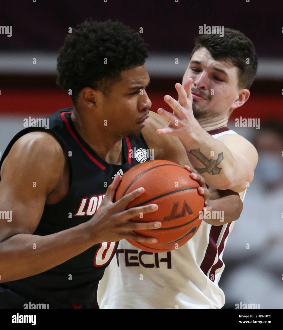 Louisville's Noah Locke, left, is defended by Virginia Tech's Hunter ...