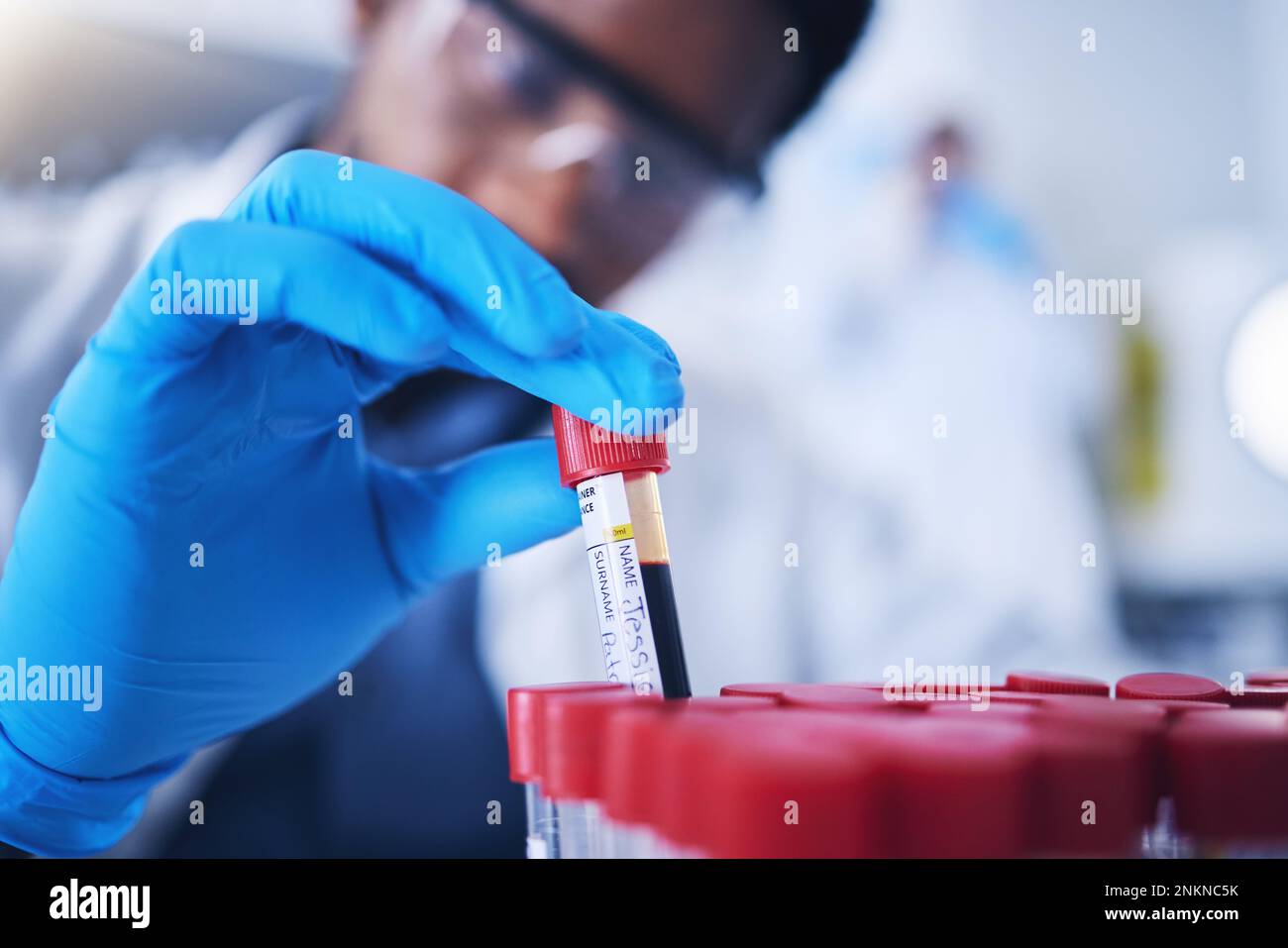 Science, blood and hands with test tube in laboratory for research ...