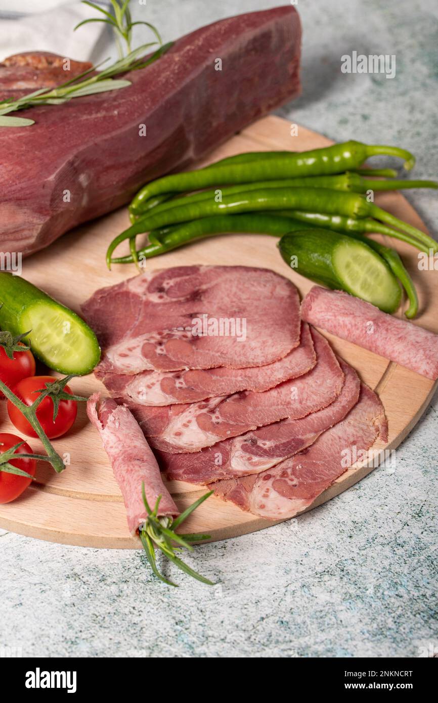 Smoked beef tongue. Sliced Smoked Veal Tongue on Wooden Cutting Board ...