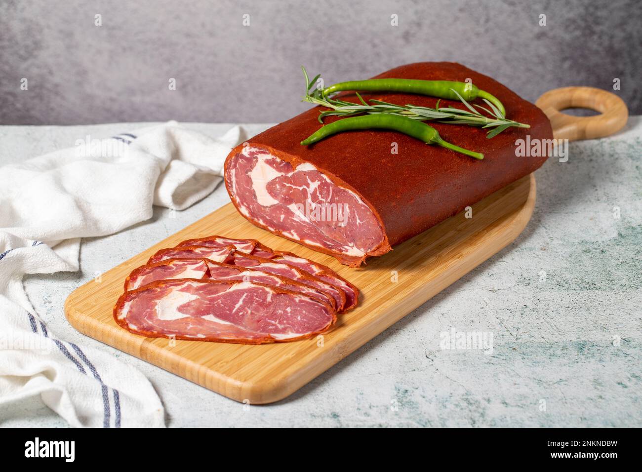 Beef ribeye pastrami. Dried turkish bacon slice on wooden Cutting Board ...