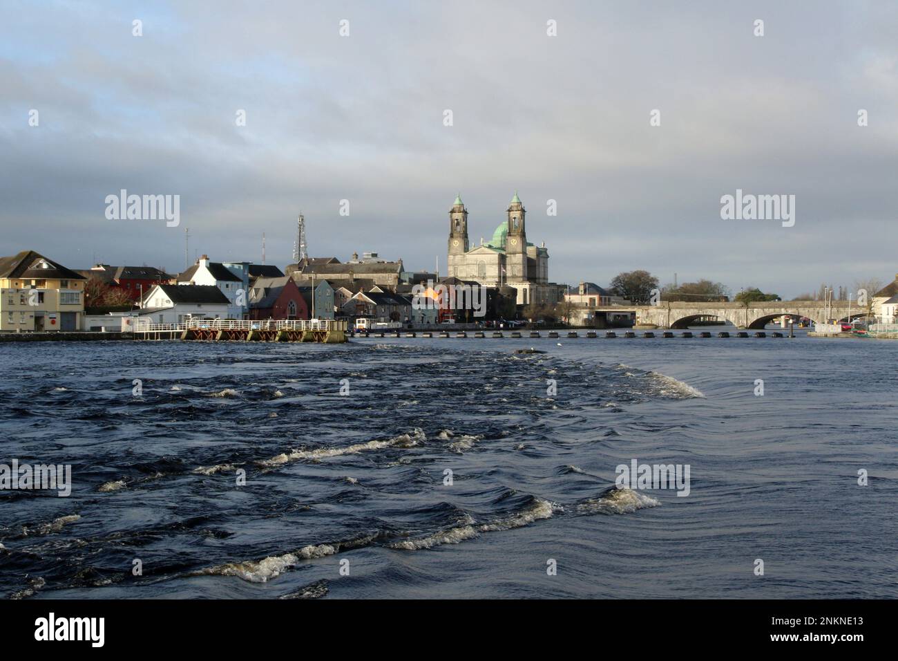 A scenic view of a tranquil body of water with a vintage bridge in the ...