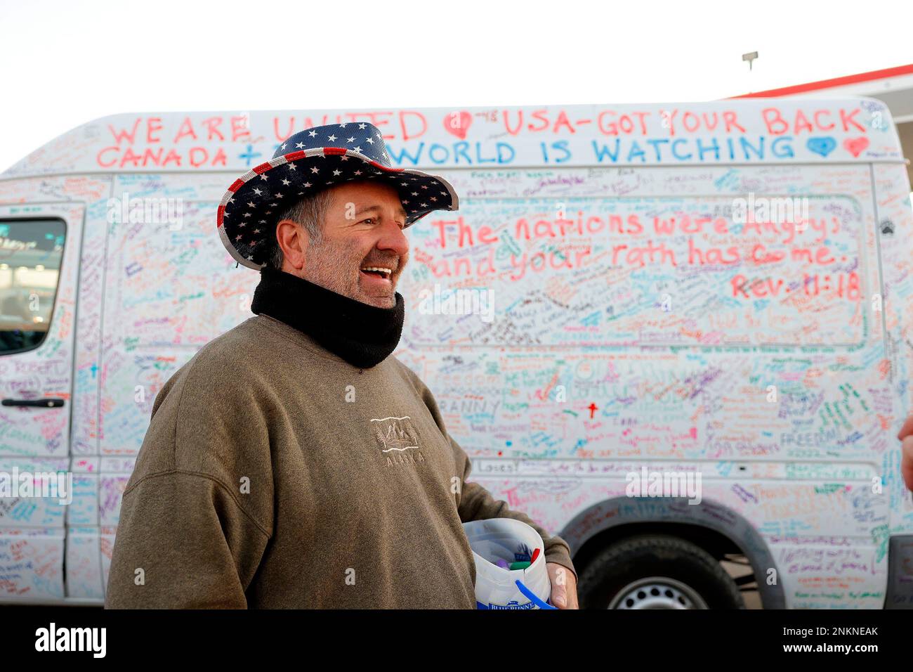 Robert Wessling of Danbury, Iowa, talks with people in front of his van ...