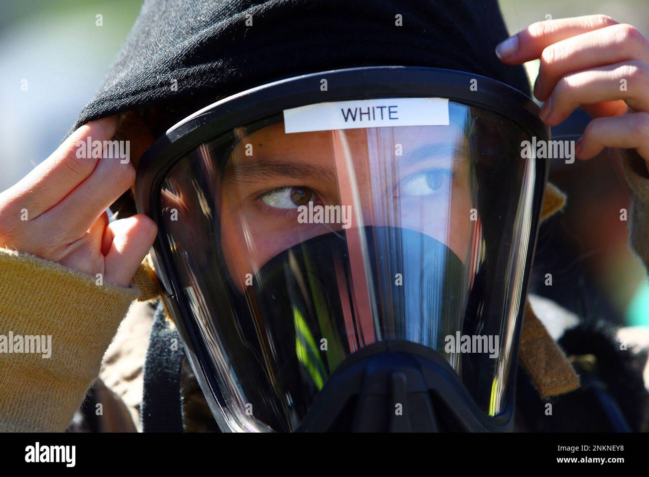 Amrine White puts on her mask before a live fire drill at Camp Blaze, a ...