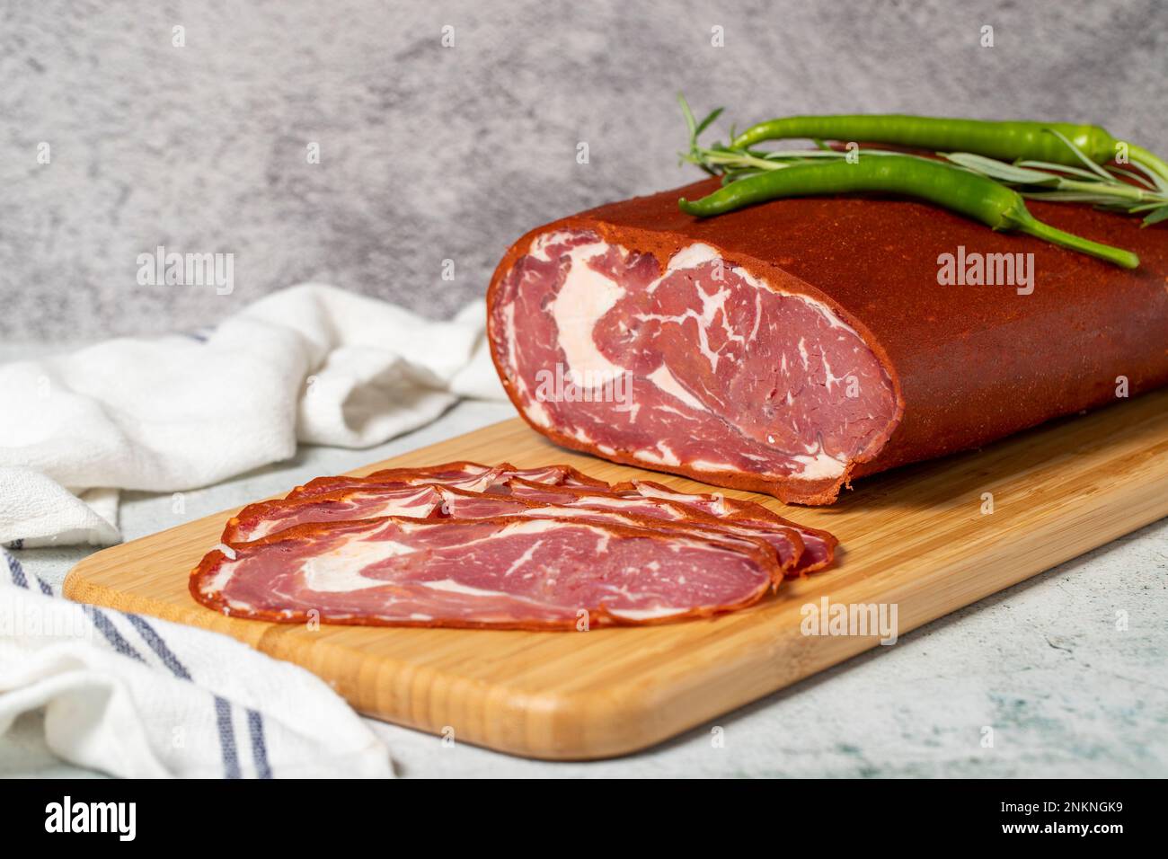 Beef ribeye pastrami. Dried turkish bacon slice on wooden Cutting Board ...