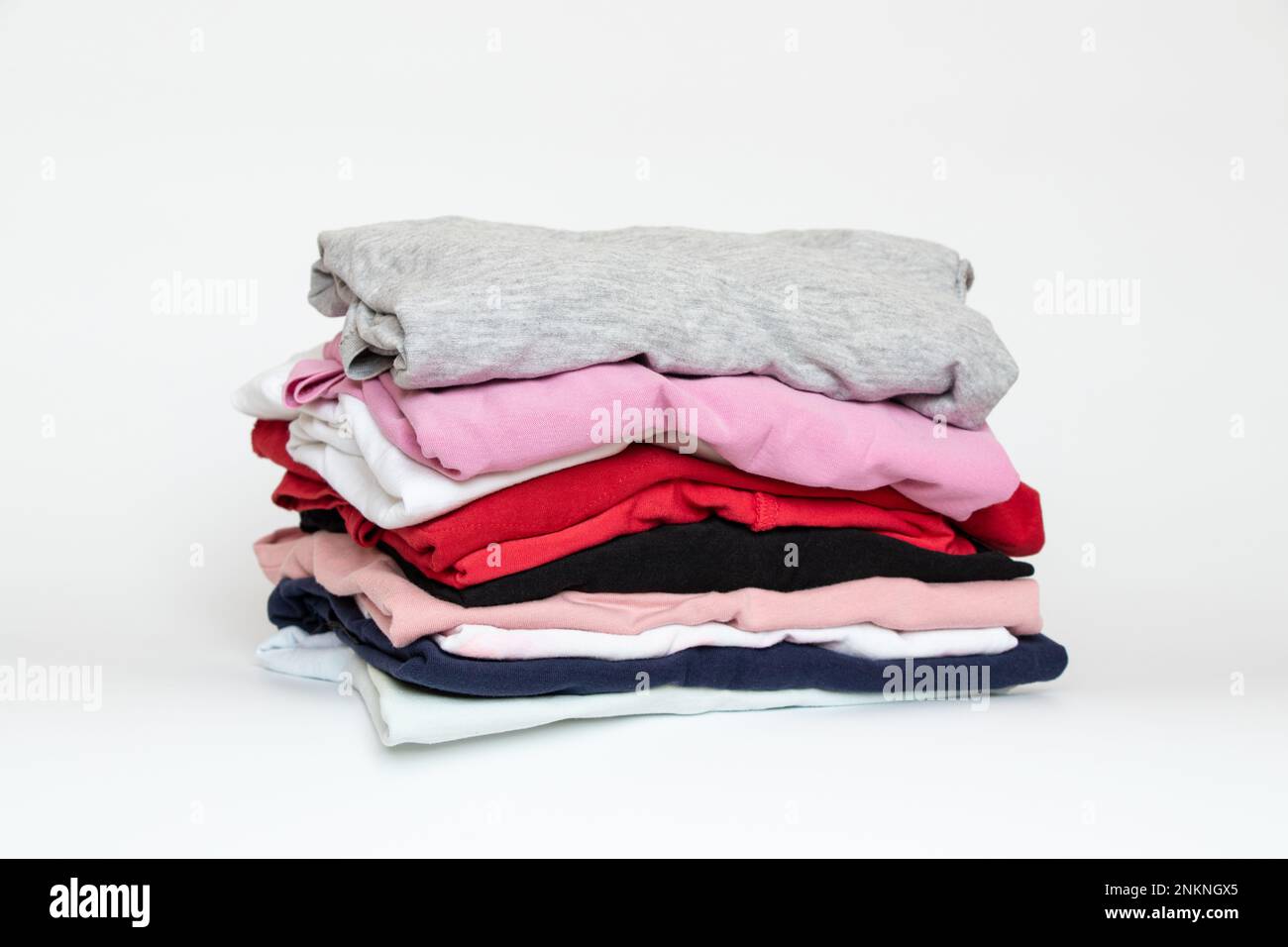 A stack of folded things on a white background close up, a lot of ...