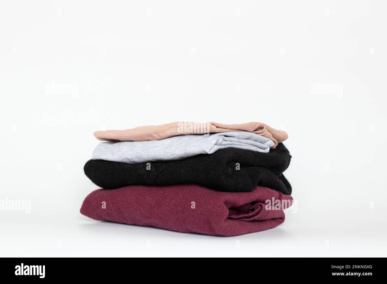 A stack of folded things on a white background close up, a lot of ...