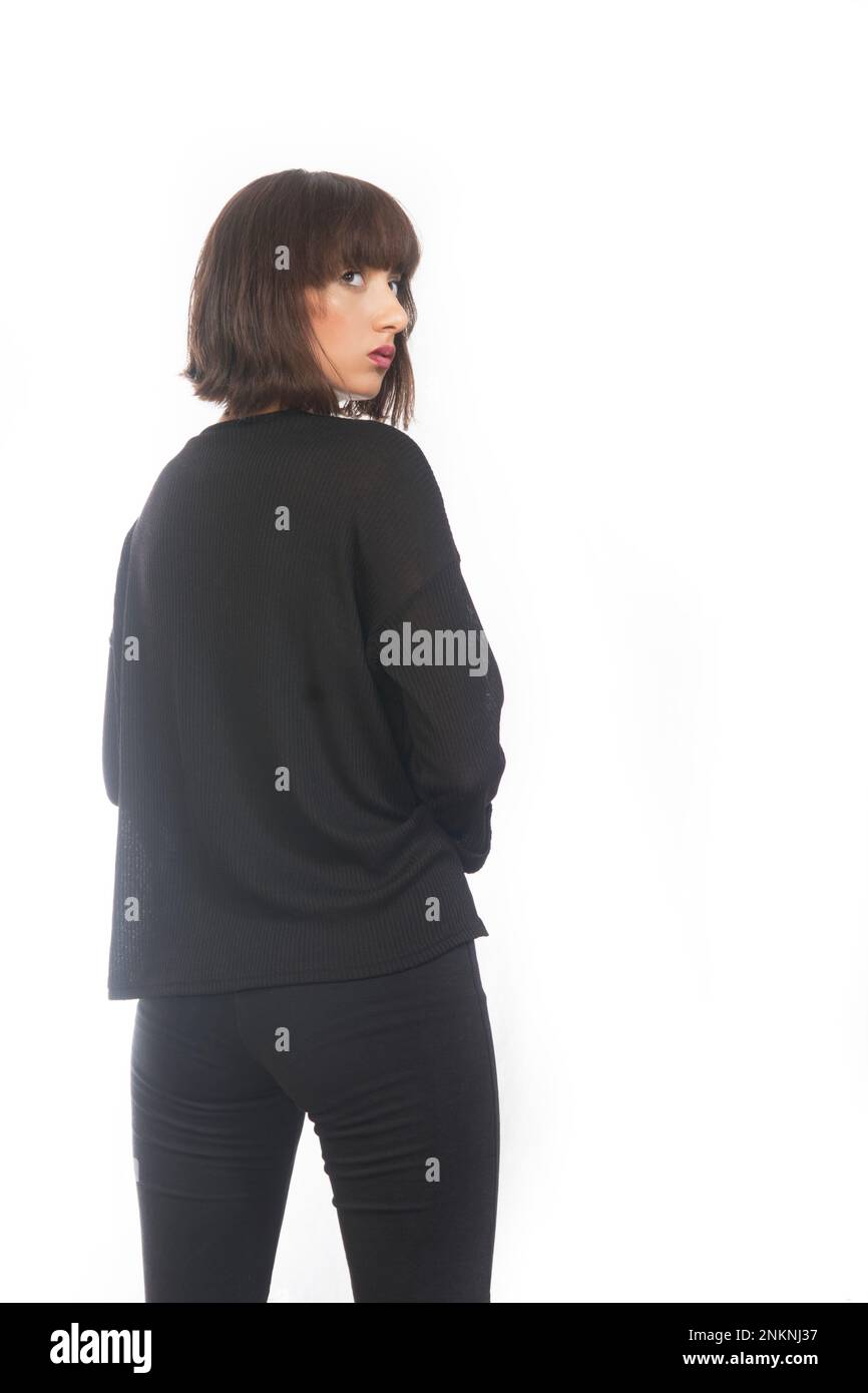 Slim woman looking back against white background Stock Photo - Alamy
