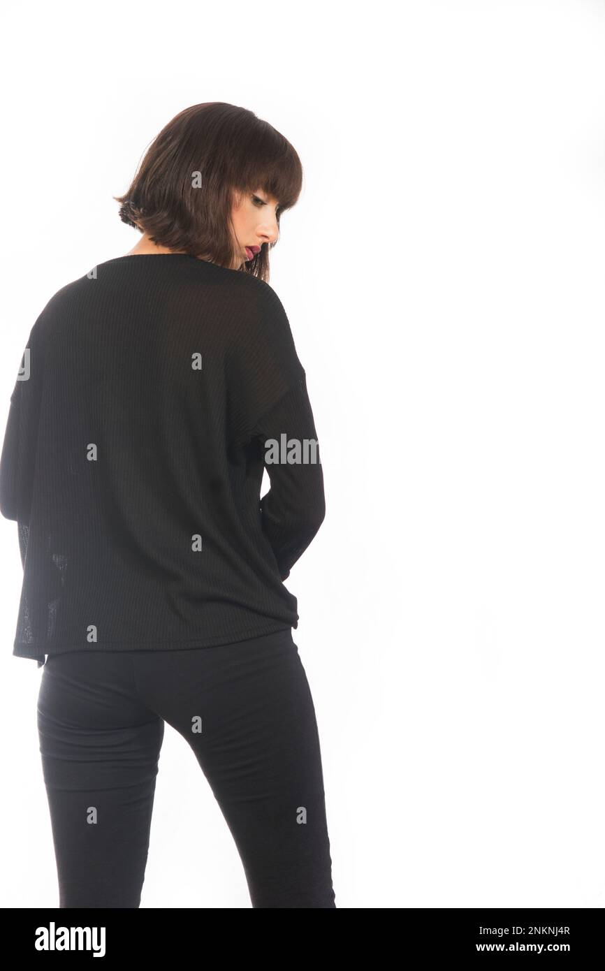 Slim woman looking over shoulder against white background Stock Photo ...