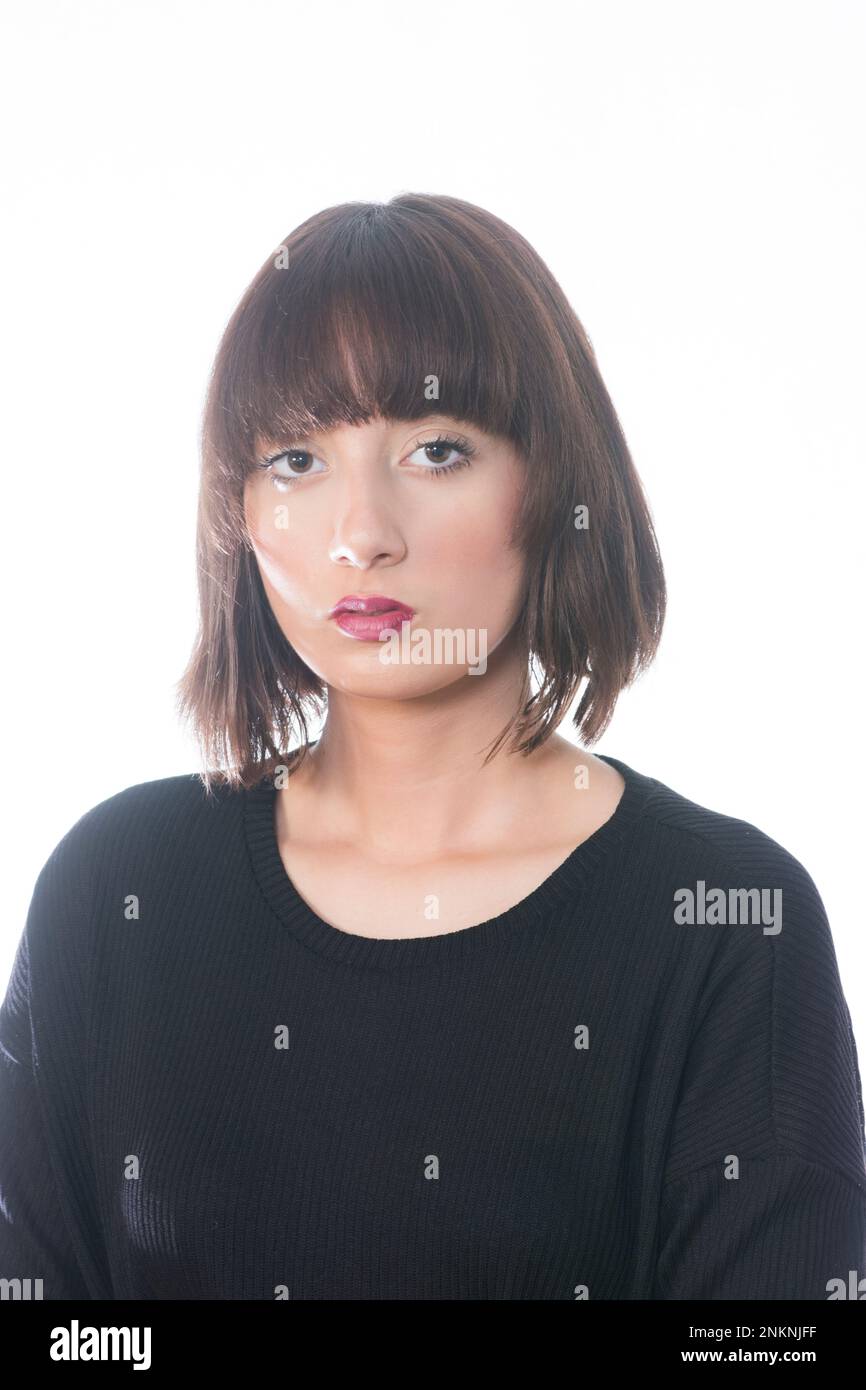 Beautiful woman looking at camera against white background Stock Photo ...