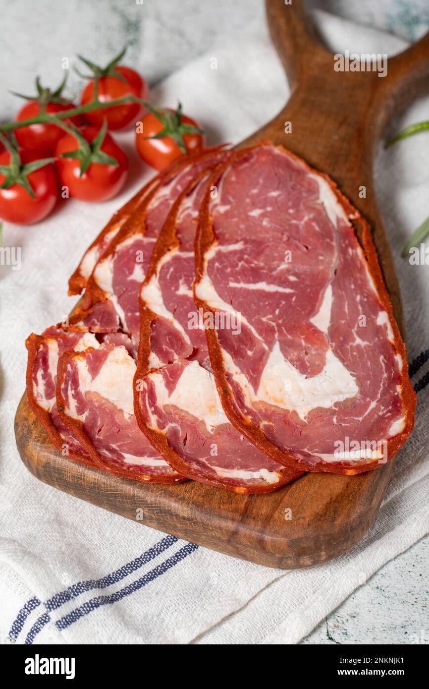 Beef ribeye pastrami. Slices of dried turkish bacon on a wooden serving ...