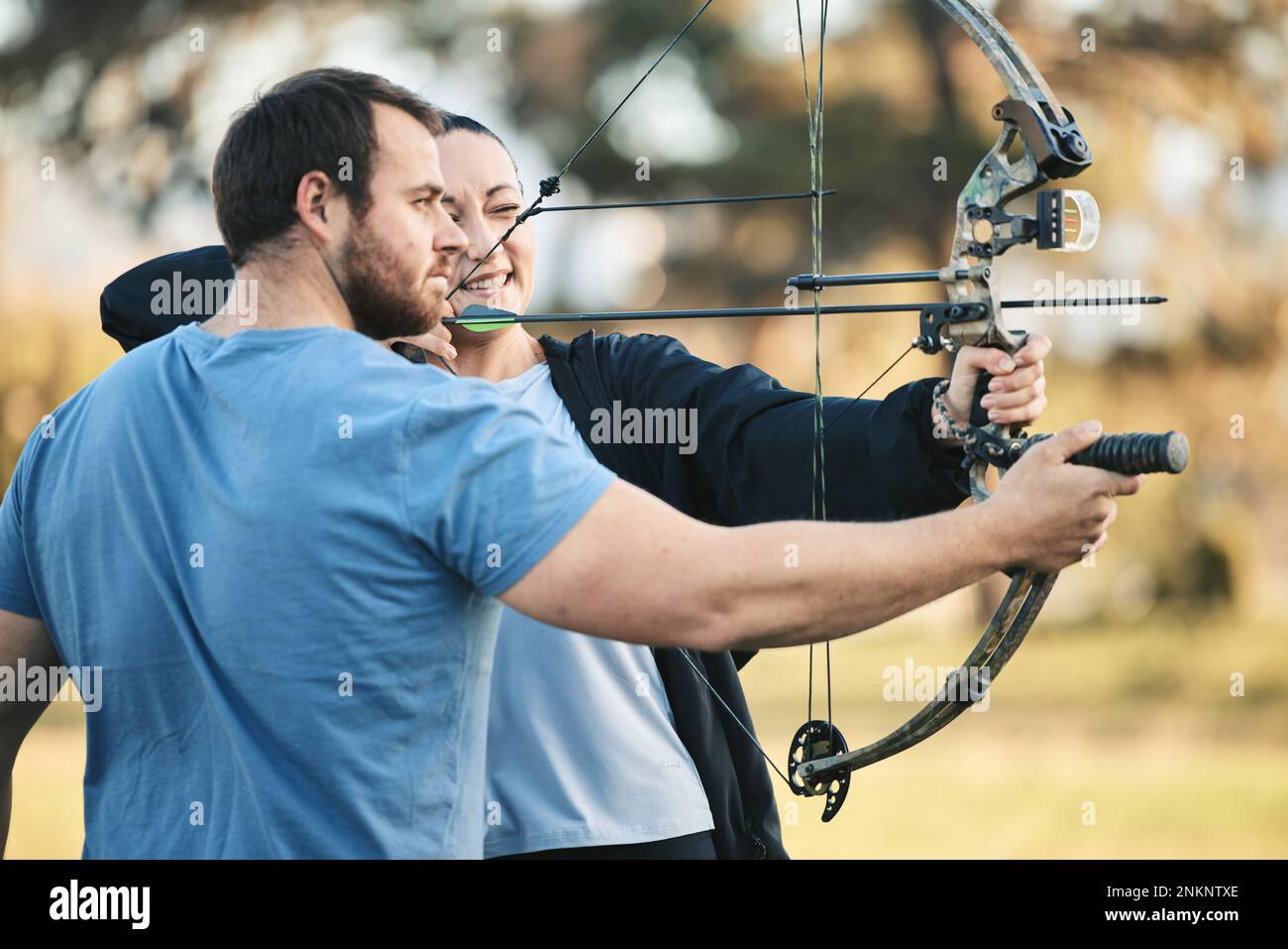 Woman man shooting bow arrow hi-res stock photography and images - Alamy