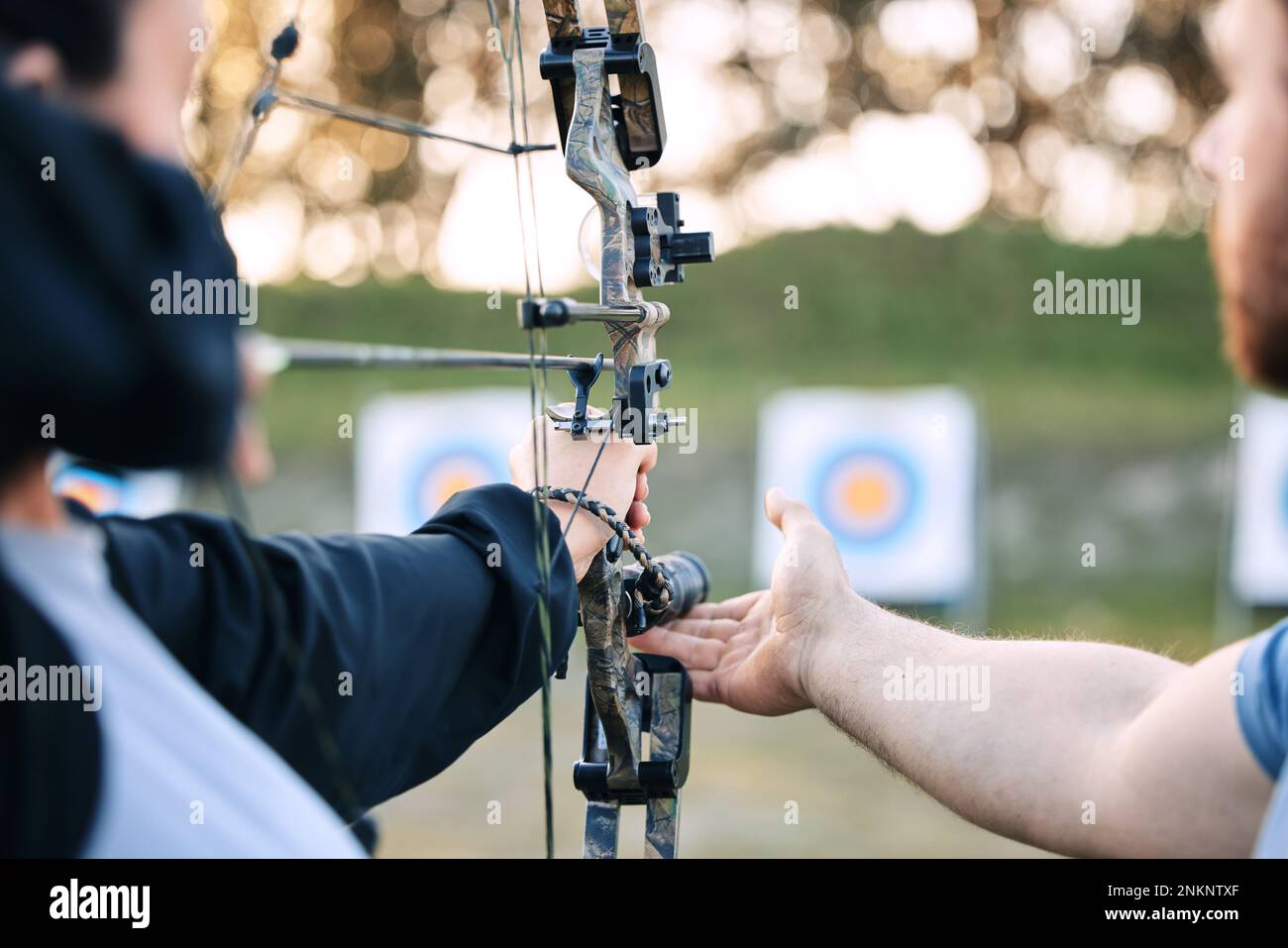 Archer hands, coach and bow or arrow learning for archery competition ...