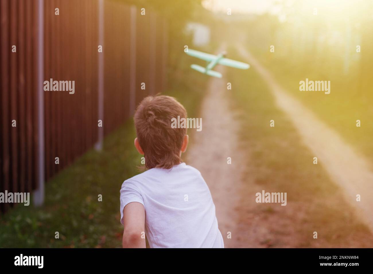 Happy child boy playing with toy airplane outdoor Stock Photo - Alamy