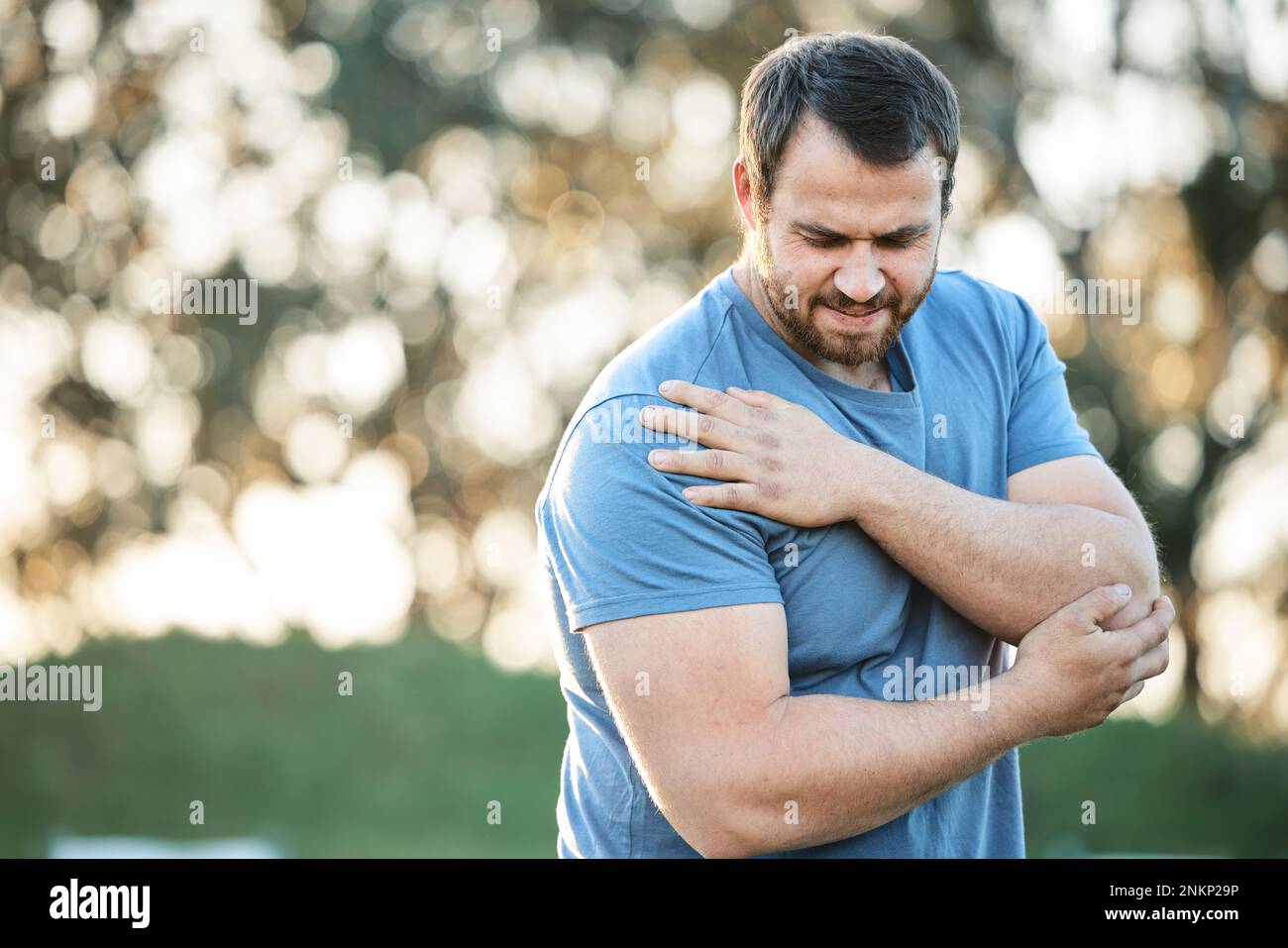 Fitness, injury and man with shoulder pain in park for running ...