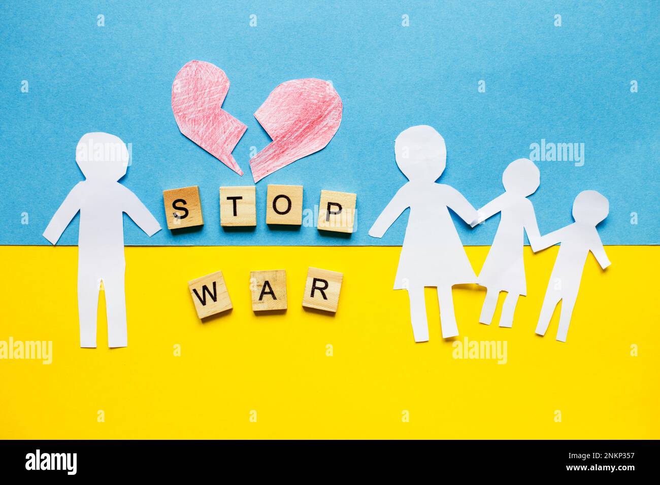 paper cut divided family on the background of the ukrainian flag. stop ...