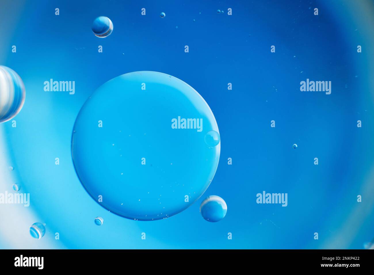abstract light blue background with oil circles . bubbles of water ...