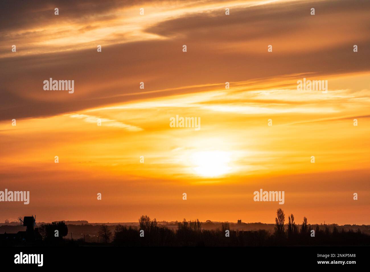 Orange sky with a hazy sunrise over the Kent landscape at Chislet in ...