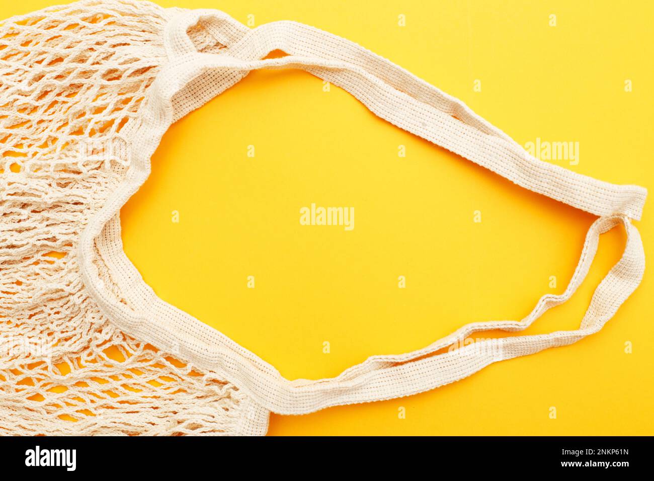 empty beige reusable string shopping bag on orange background. plastic ...