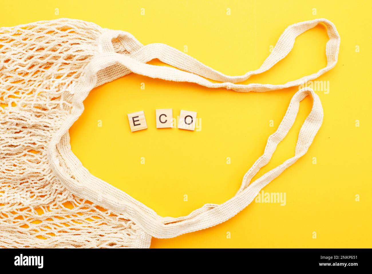 empty beige reusable string shopping bag on orange background. plastic ...