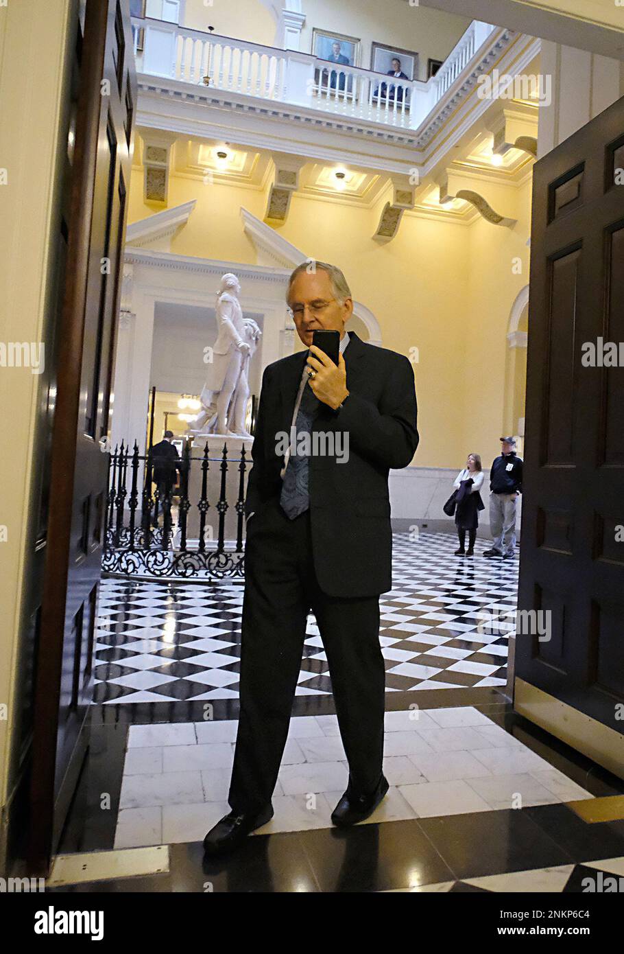 Senate Minority Leader Tommy Norment, Jr., R-James City, takes a phone ...