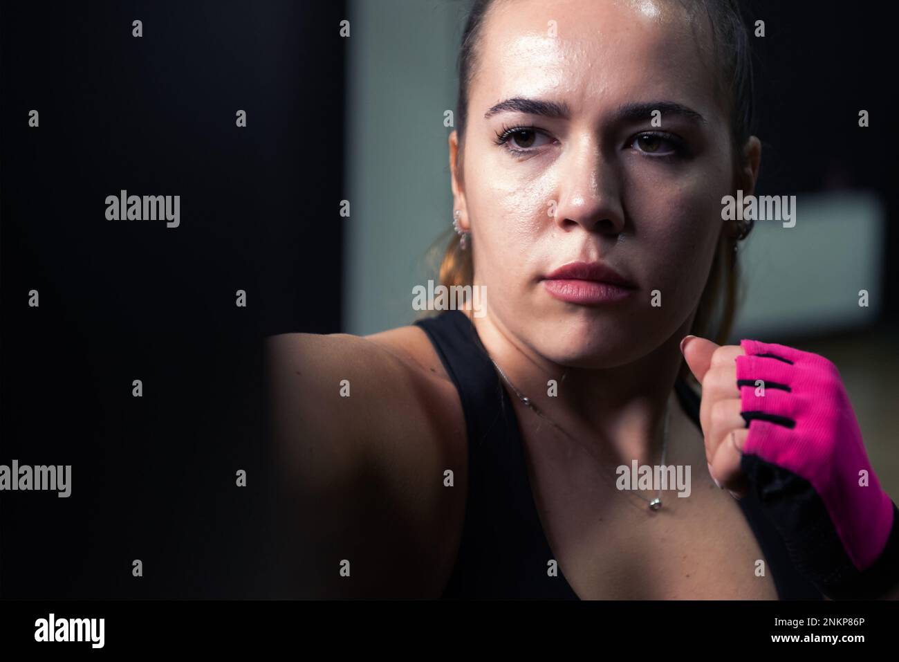 Pretty female kickboxer training with a punching bag Stock Photo - Alamy