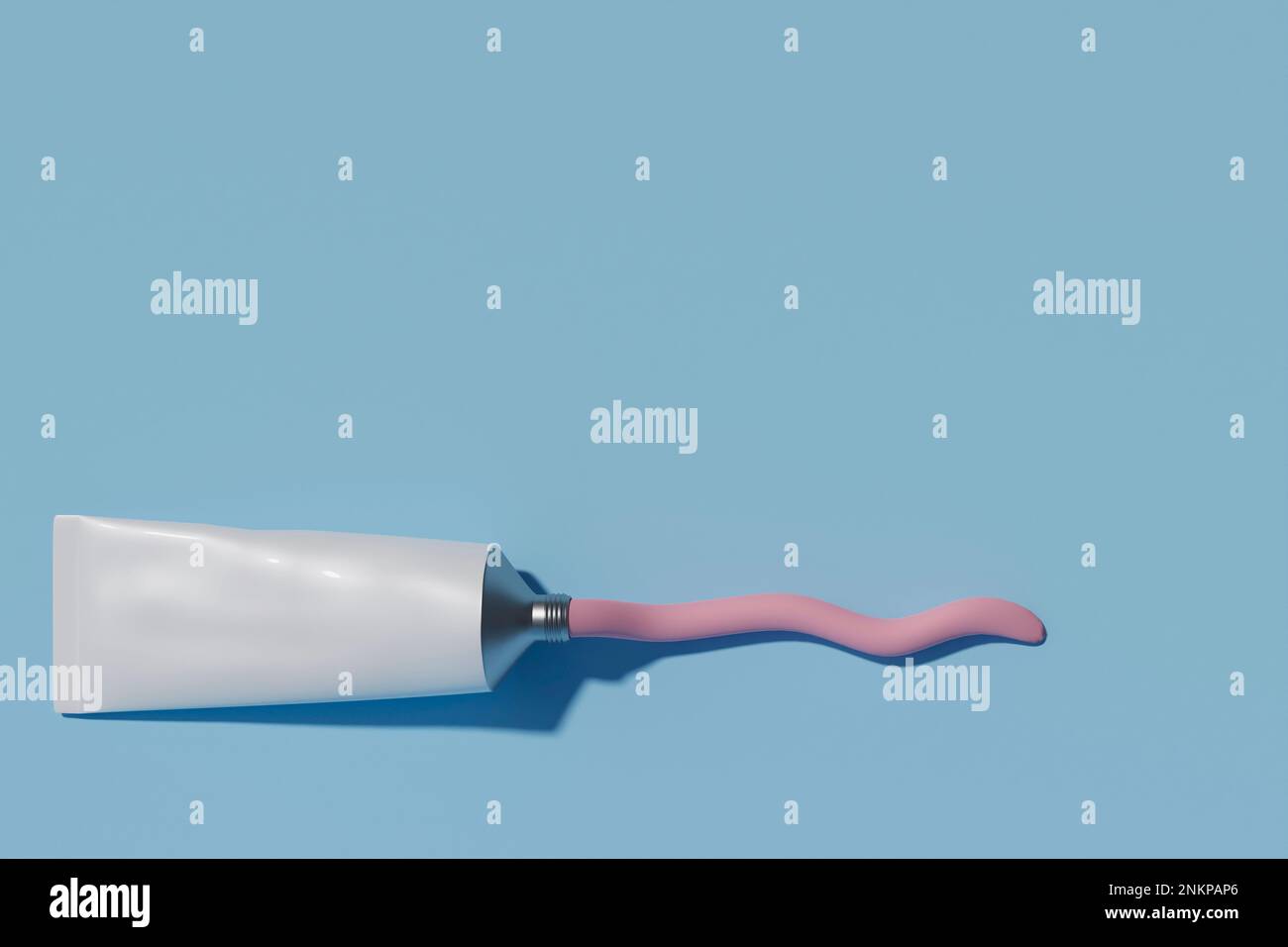 Squeezed pink toothpaste from white tube on blue background with ...