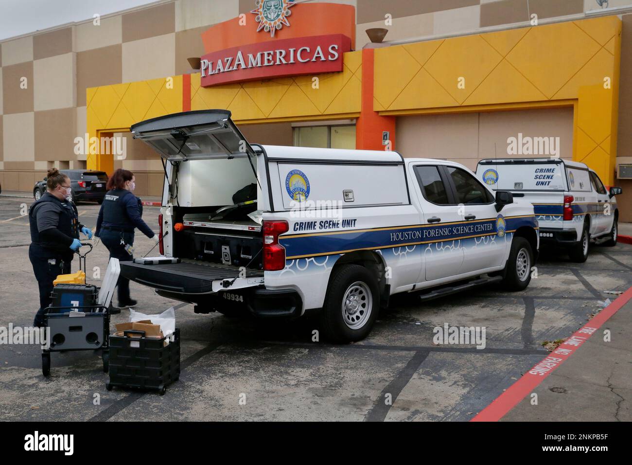 Investigators with the Houston Forensic Science Center unload equipment ...
