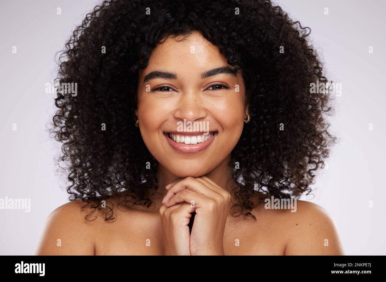 Portrait, face and afro with a model black woman in studio on a gray ...