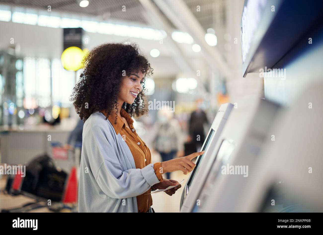 Black woman, airport and smile by self service station for ticket ...