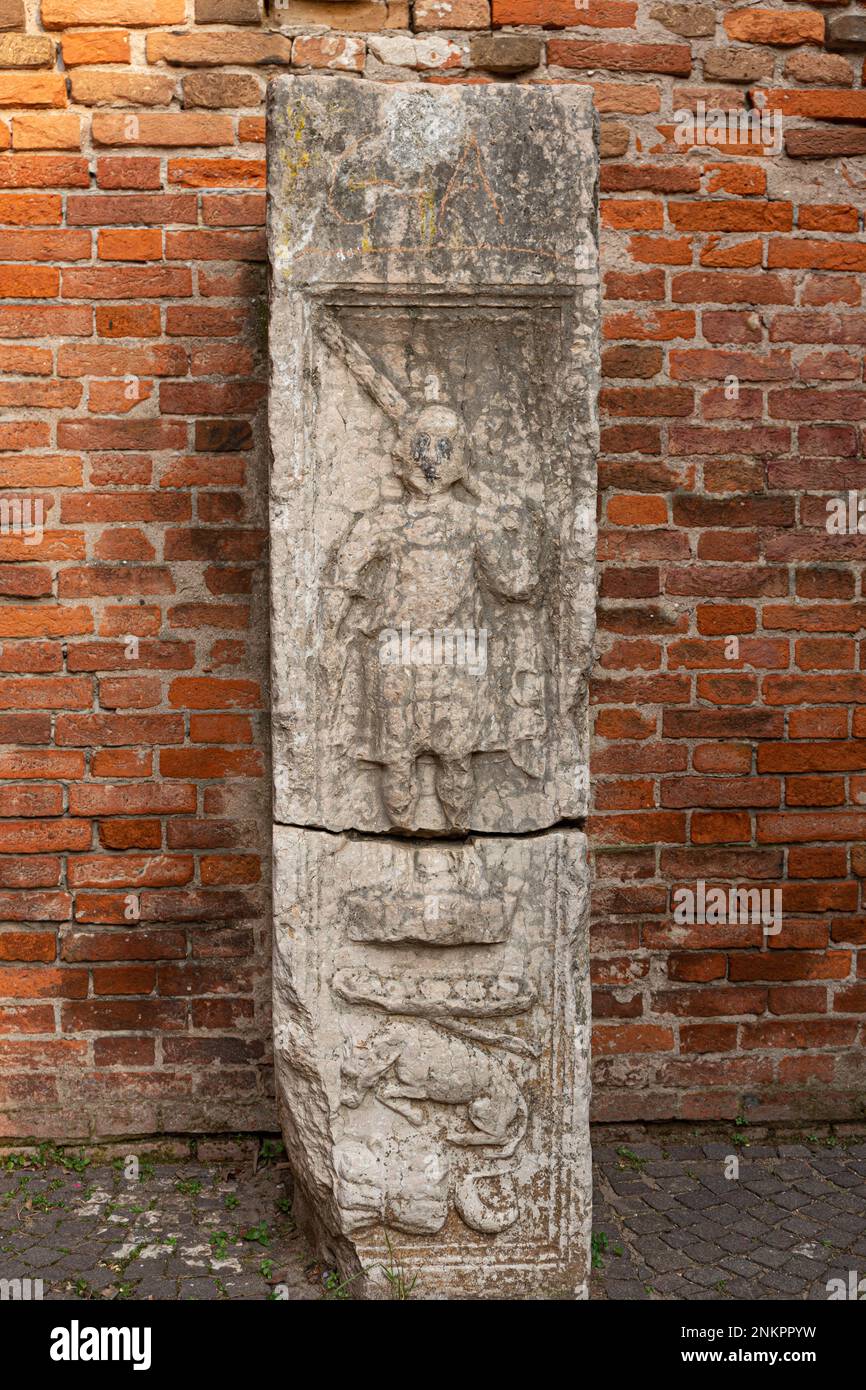 Historic stone relief carving embedded in a brick wall. Architectural ...