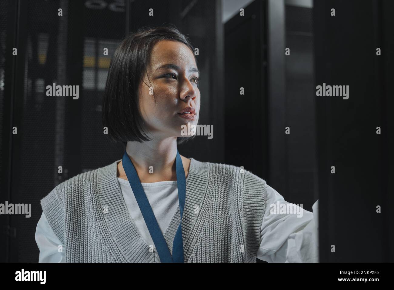 Serious, maintenance or IT woman in server room for analysis, engineer ...