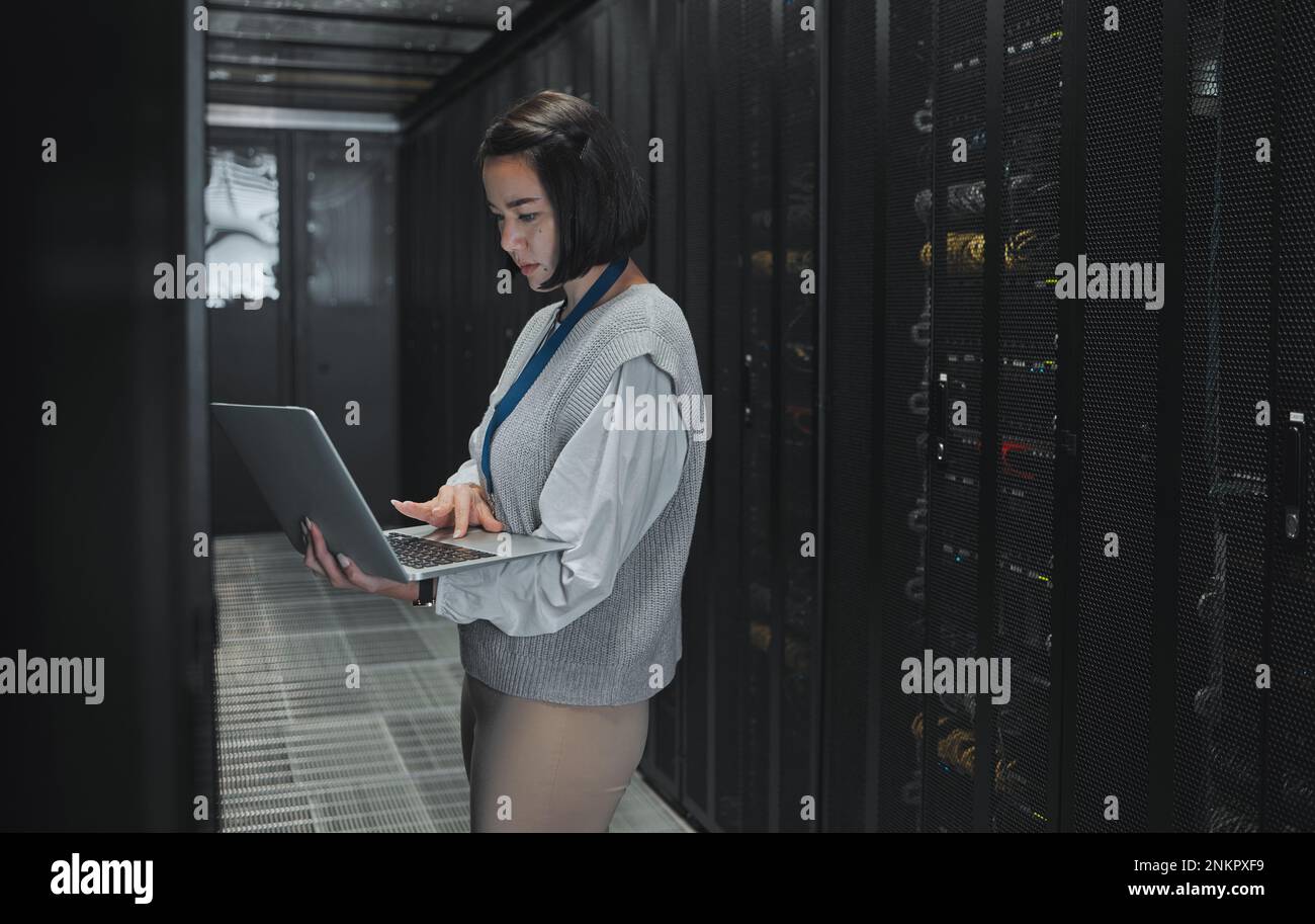 Server room, laptop and technician woman for data center management ...