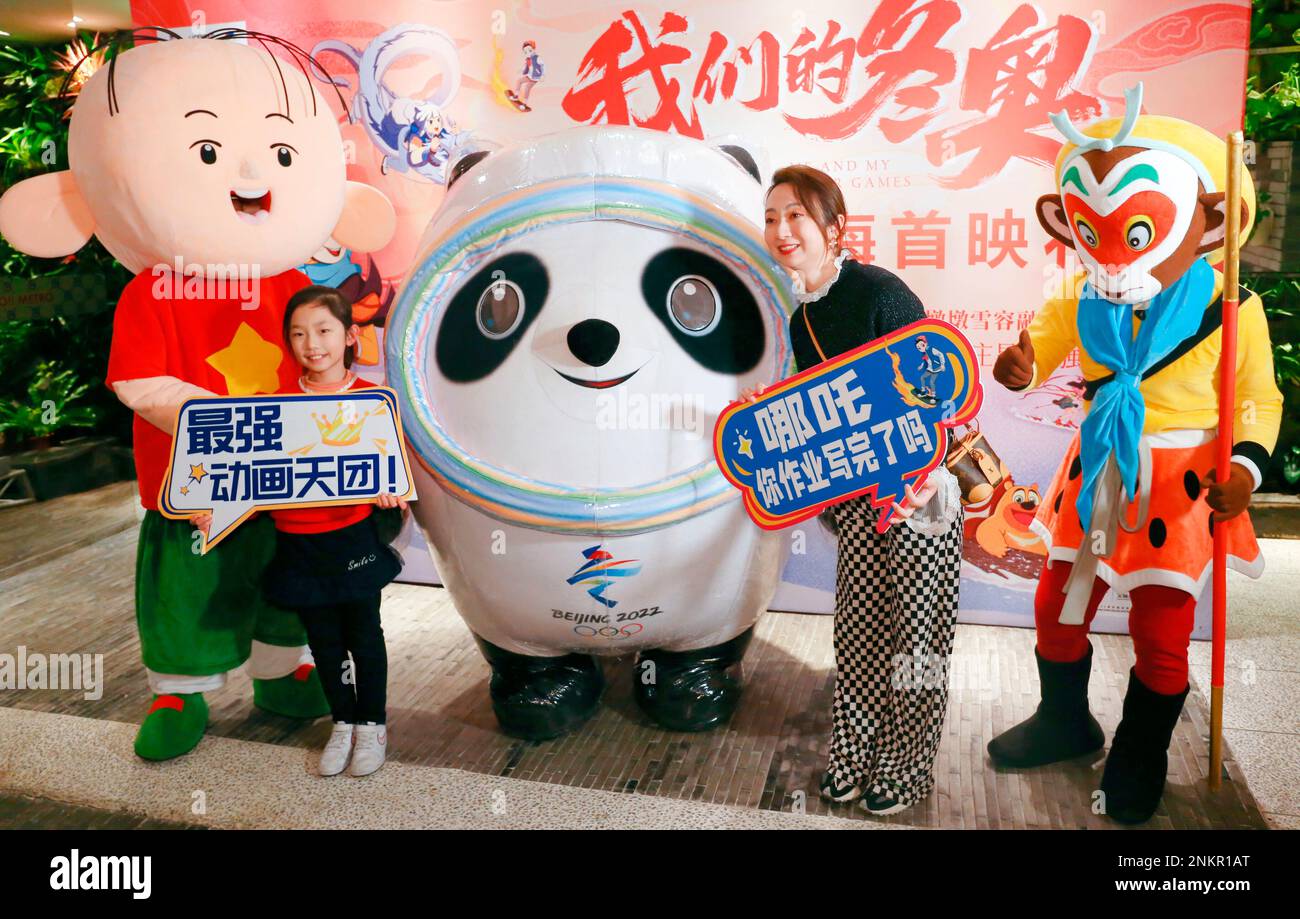 People react to Bing Dwen Dwen, center, the mascot of the 2022 Beijing Winter Olympics, in a ...
