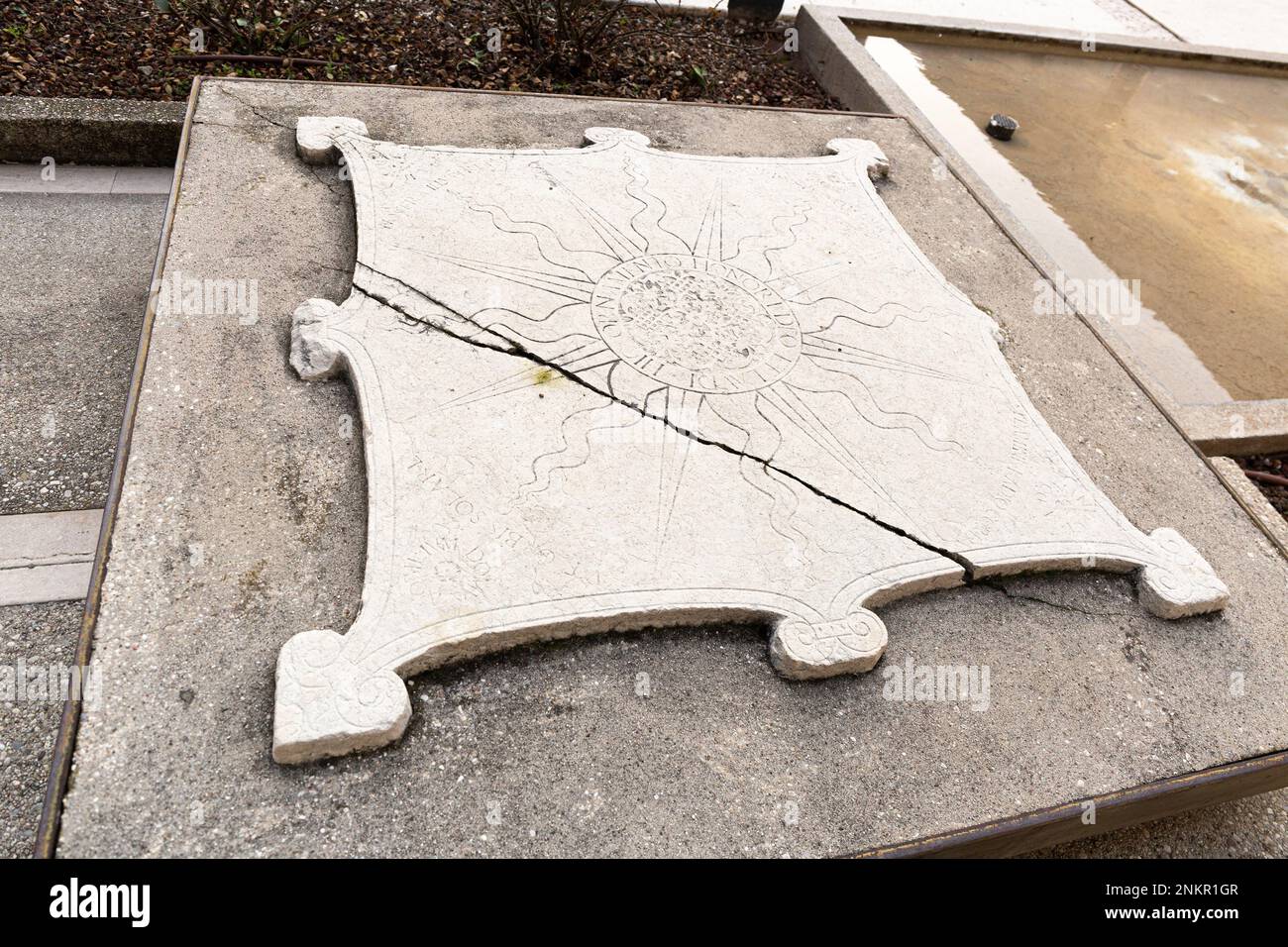 Ancient stone sundial with crack from different angle. Showing sunburst ...
