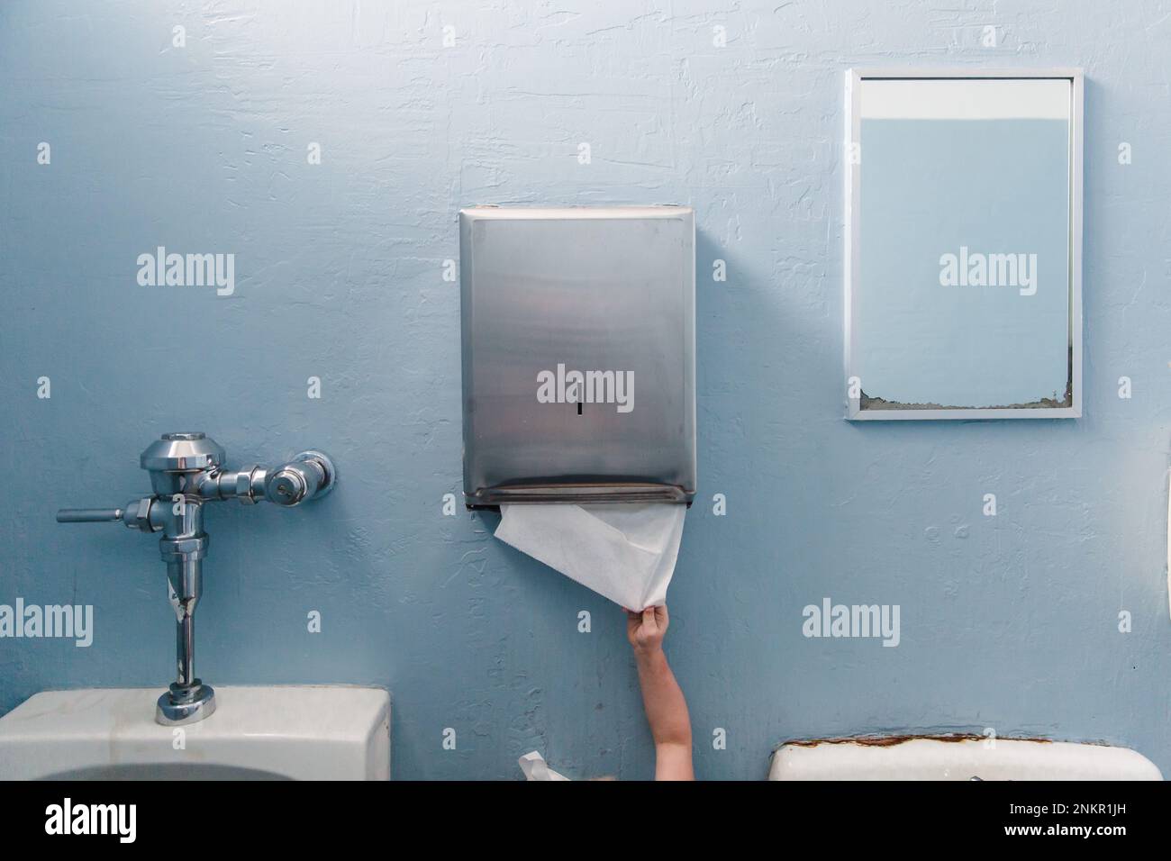 Child reaching for paper towel from dispenser in public washroom Stock ...