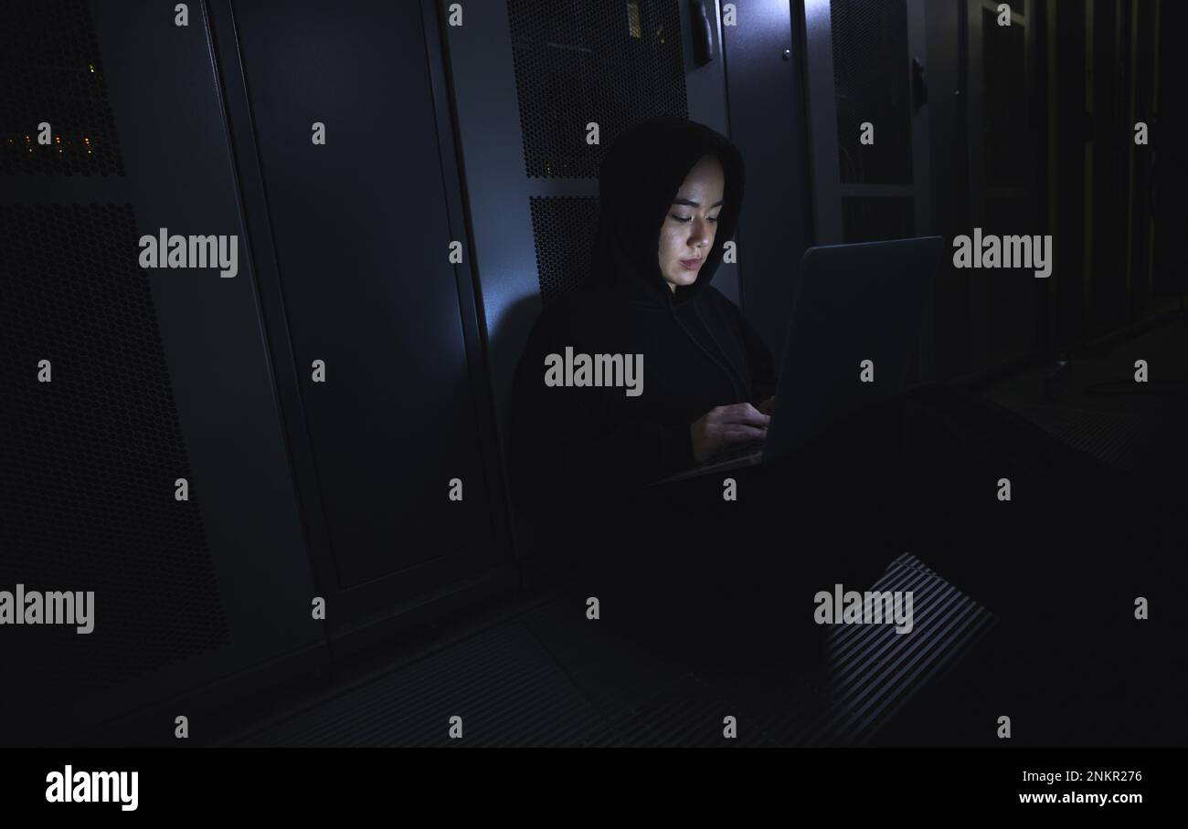 Hacking Laptop And Hacker Woman In Dark Server Room For Coding