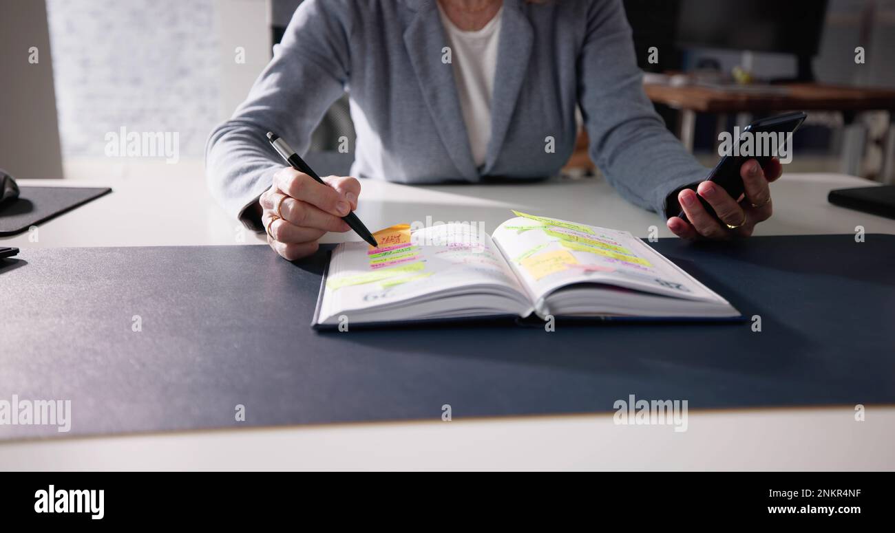 Calendar Schedule List At Desk And In Mobile Phone Stock Photo - Alamy