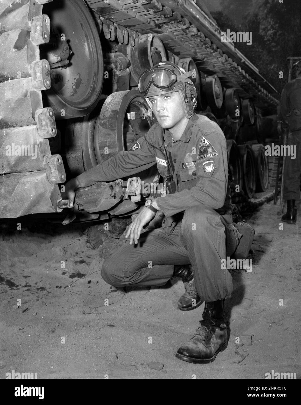 Elvis Presley in US Army uniform posing by an American Tank, on set for ...