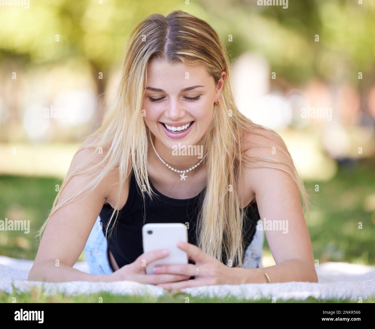 Happy, relax or girl with phone in park with smile for online meme ...